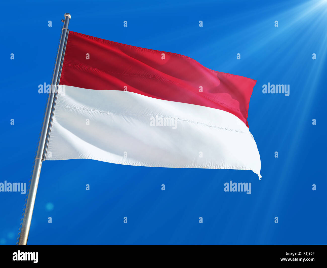Indonesia National Flag Waving on pole against deep blue sky background ...