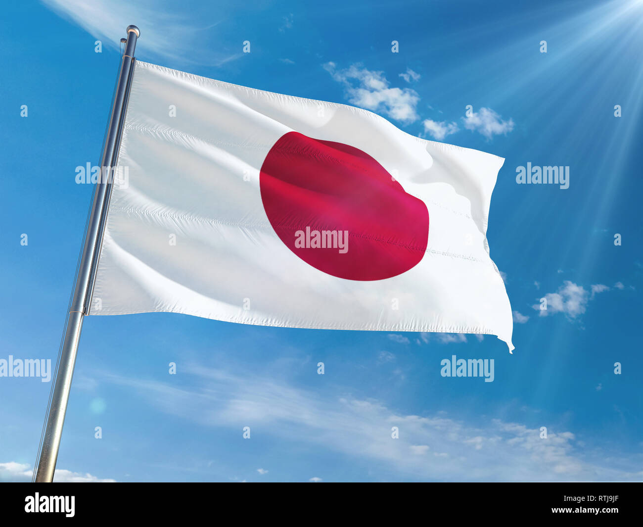 Japan National Flag Waving on pole against sunny blue sky background ...