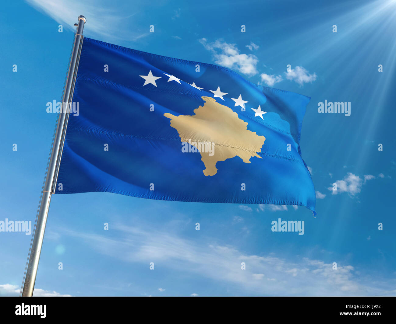 Kosovo National Flag Waving on pole against sunny blue sky background ...
