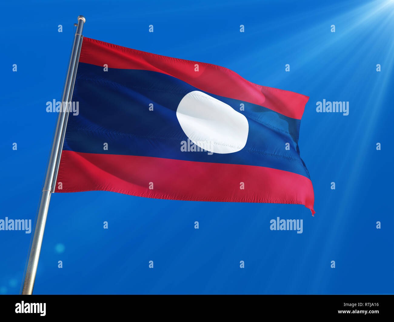 Laos National Flag Waving on pole against deep blue sky background ...