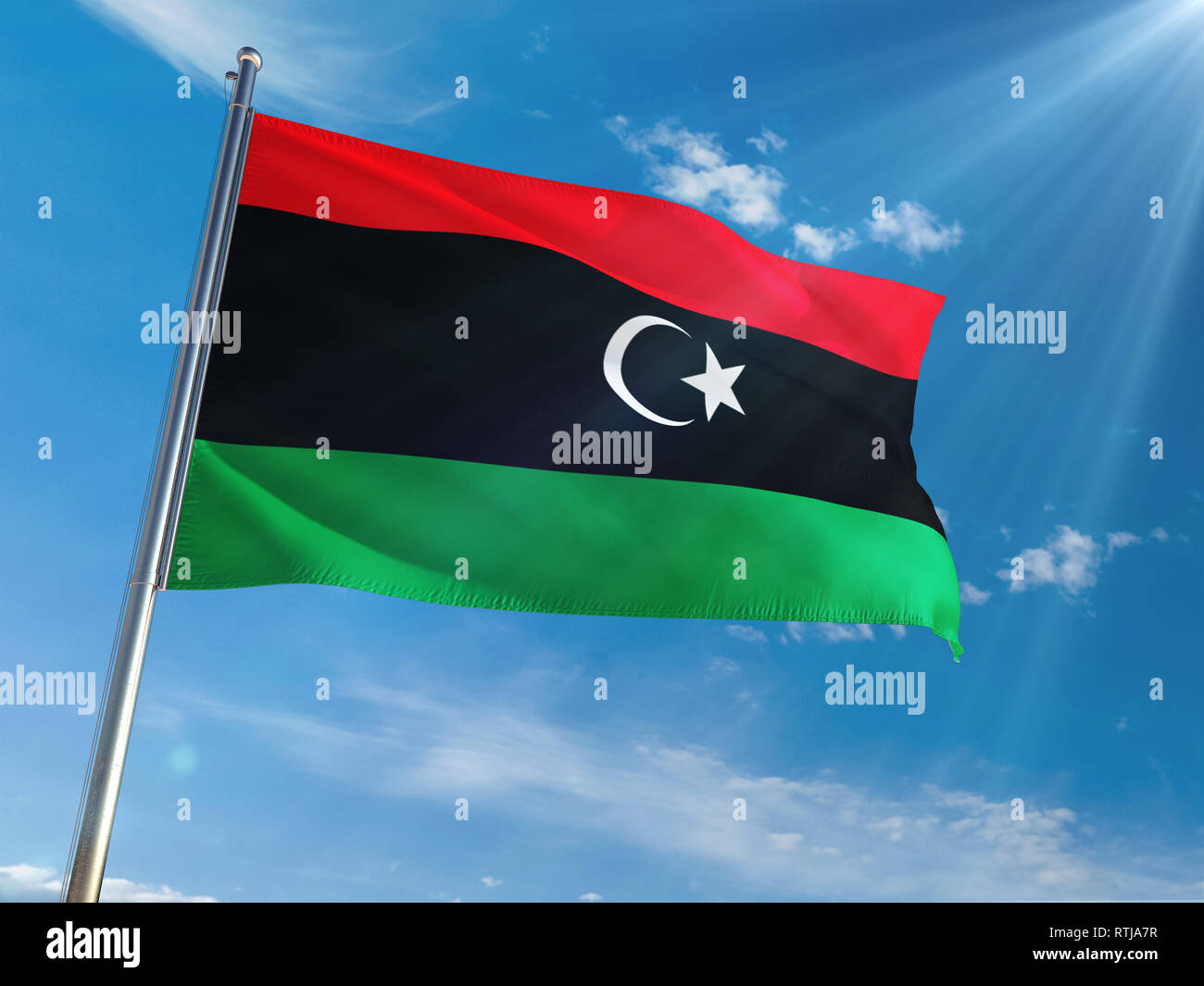 Libya National Flag Waving on pole against sunny blue sky background ...
