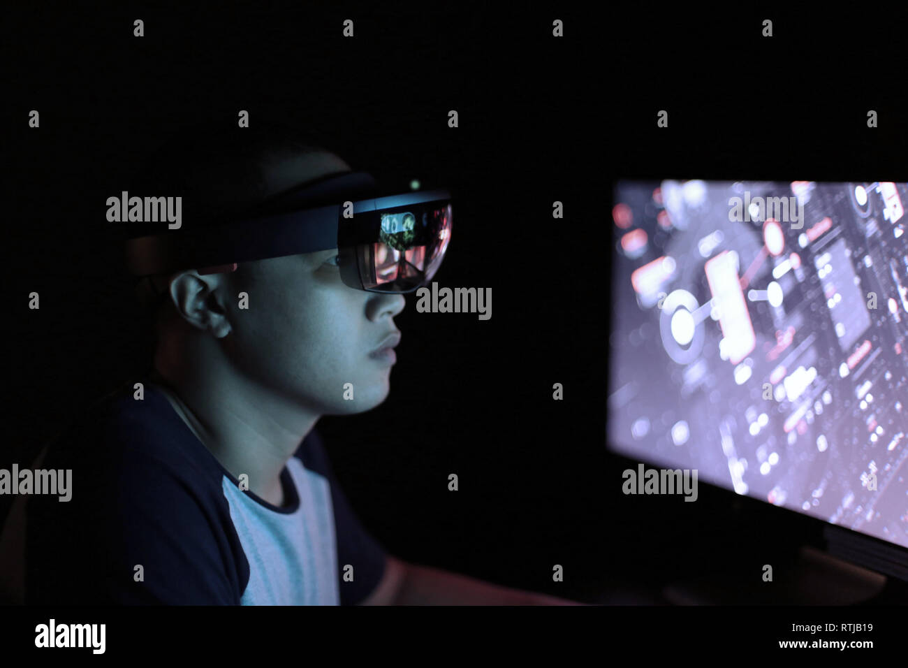 Portrait of young man with 3D virtual reality eye wear glasses hololens ...