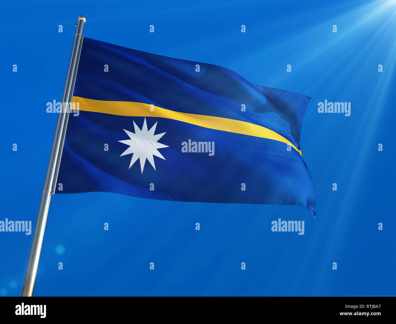 Nauru National Flag Waving on pole against deep blue sky background ...