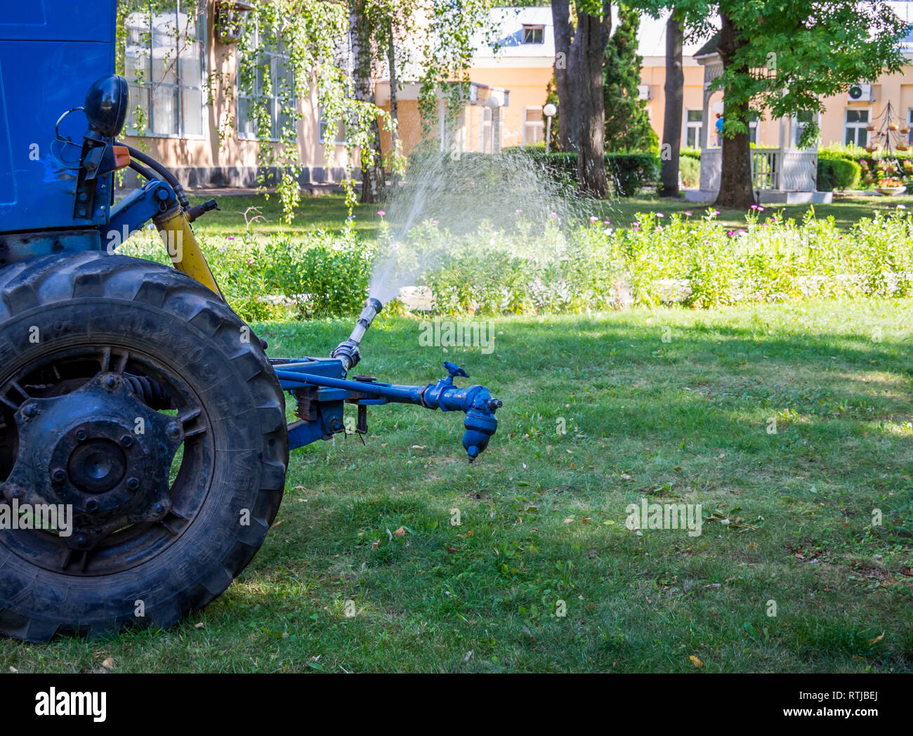 Watering the lawn in the park using special equipment Stock Photo - Alamy