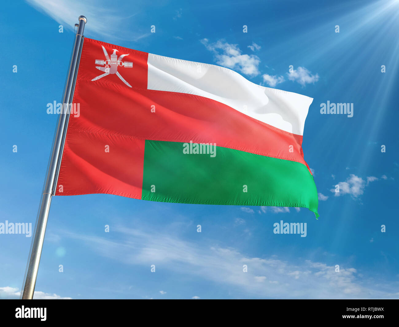 Oman National Flag Waving on pole against sunny blue sky background ...