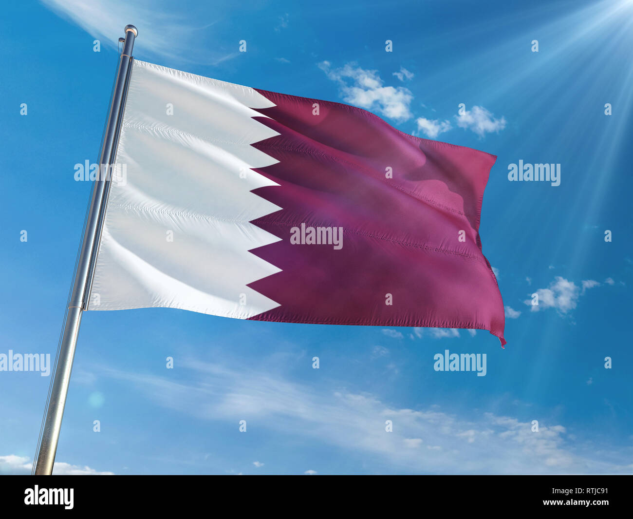 Qatar National Flag Waving on pole against sunny blue sky background ...