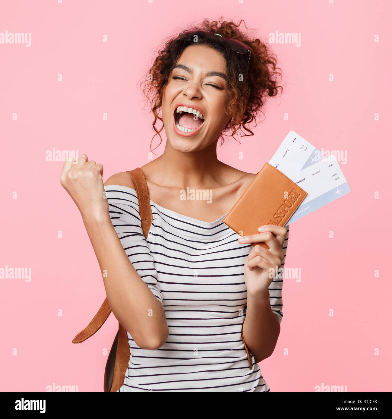 African-american woman with tickets screaming, clenching fist like ...