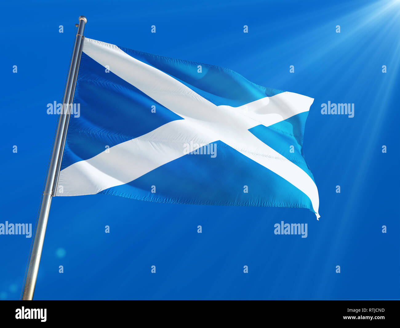 Scotland National Flag Waving on pole against deep blue sky background ...