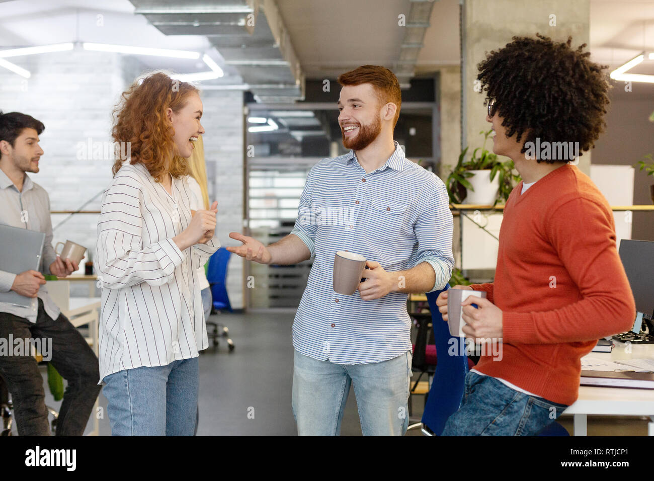 Cheerful colleagues enjoying coffee break in office Stock Photo - Alamy