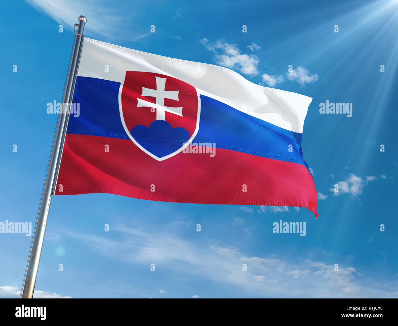 Slovakia National Flag Waving on pole against sunny blue sky background ...