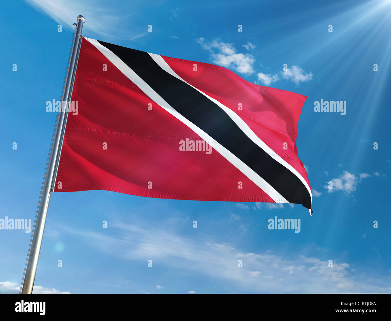 Trinidad And Tobago National Flag Waving on pole against sunny blue sky background. High ...