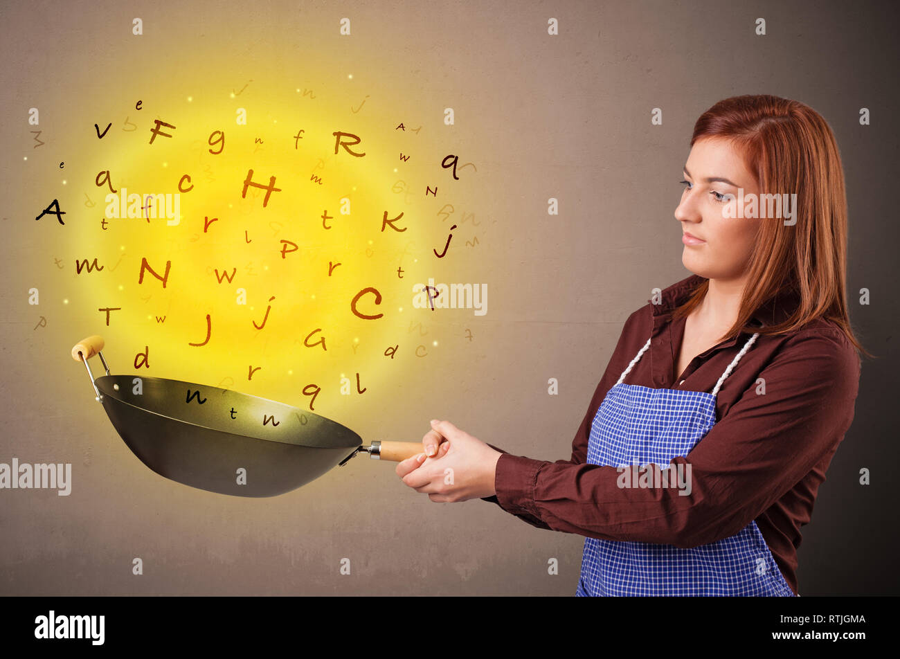 Young person cooking letters in wok Stock Photo - Alamy