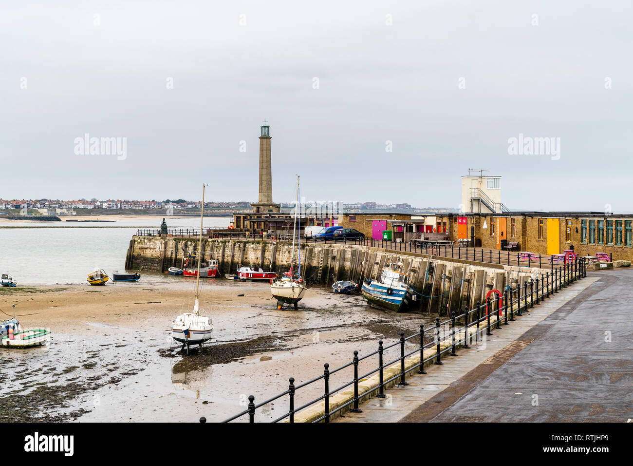Margate harbour at low tide. Single curved stone jetty with small ...