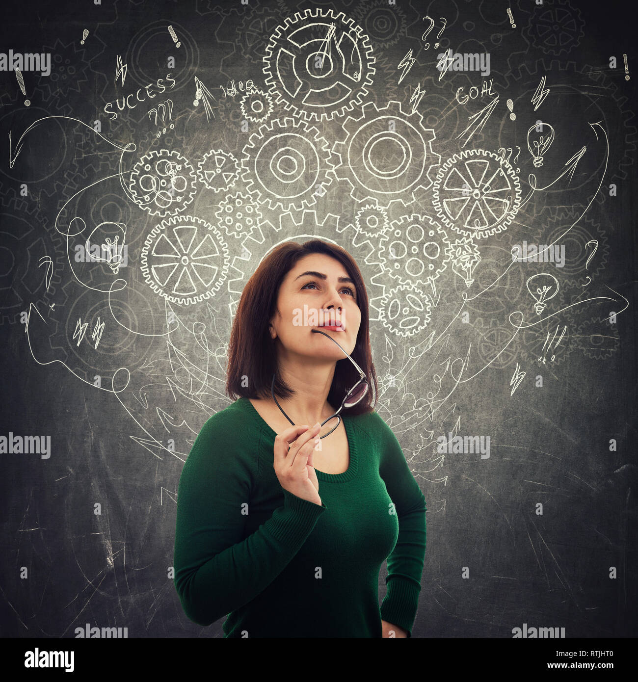 Smart woman meditate looking up thinking of new ideas in front of ...