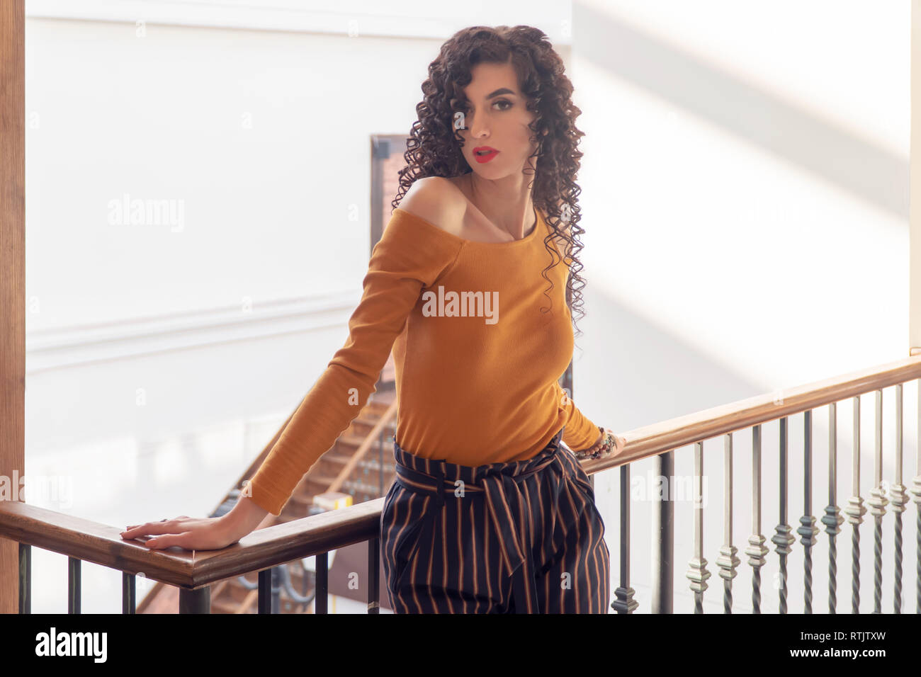 portrait of a beautiful woman leaning her back on the railing Stock ...