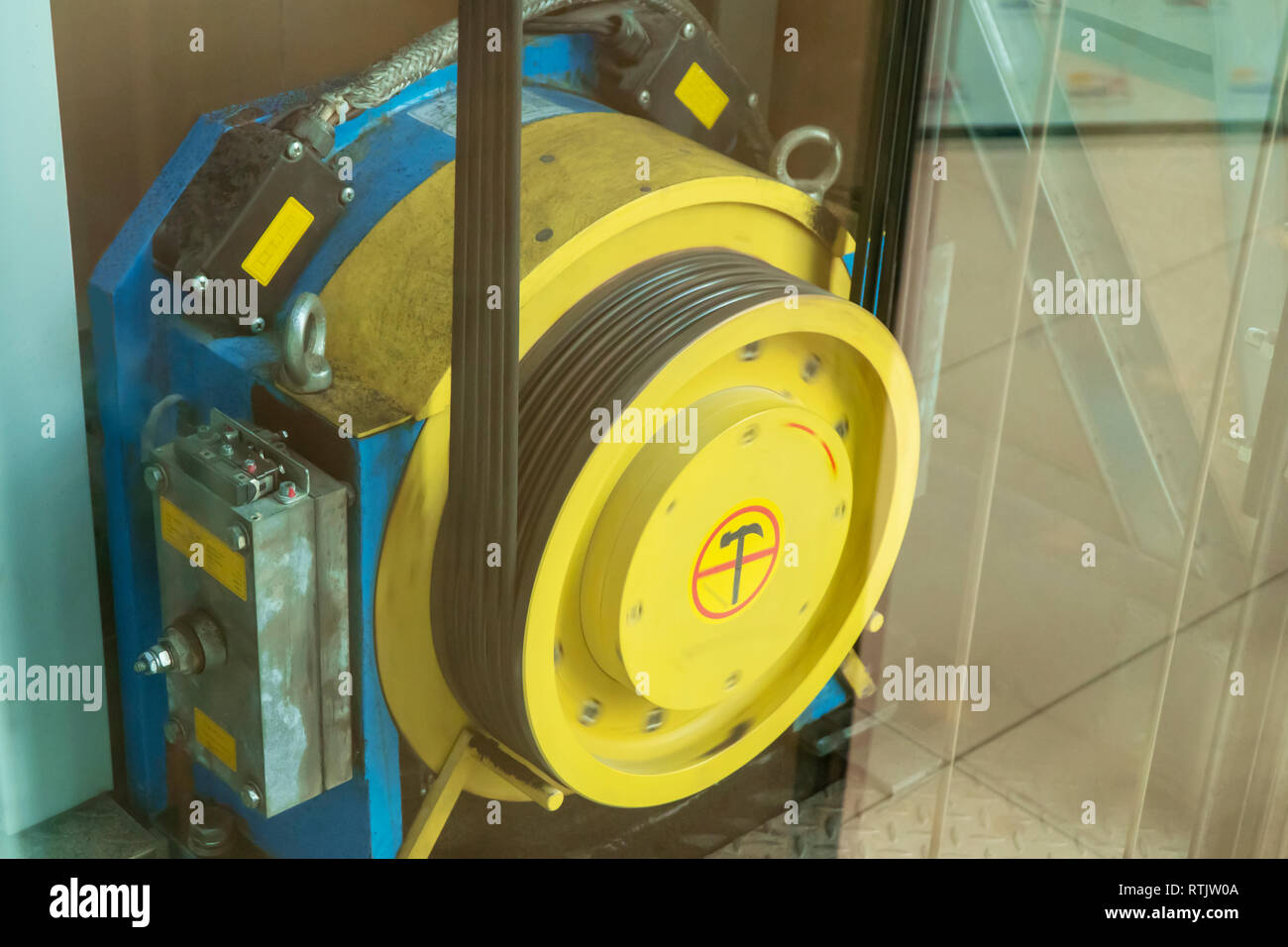 yellow rotating lift motor with straps extending upwards Stock Photo ...