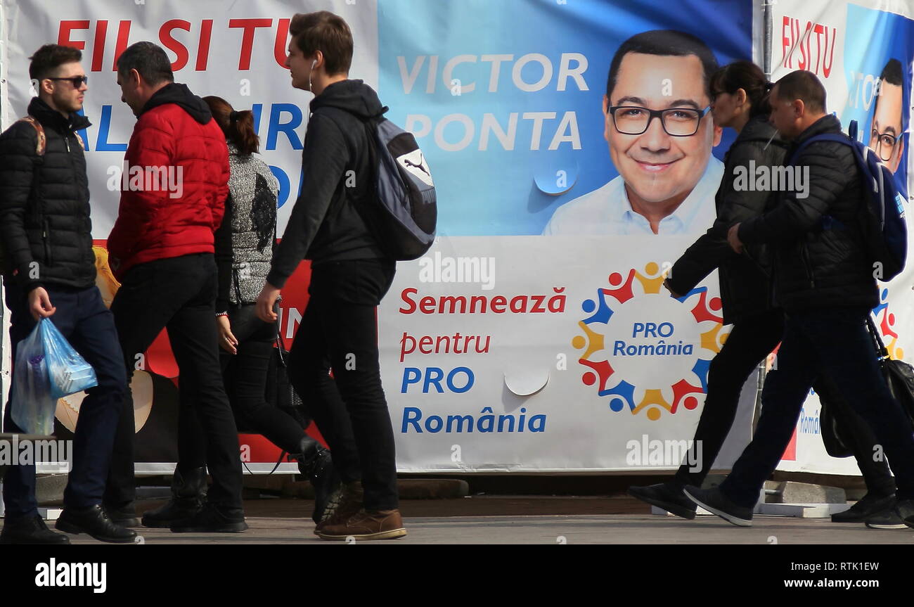 Bucharest, Romania - March 01, 2019: People passes the poster of the ...