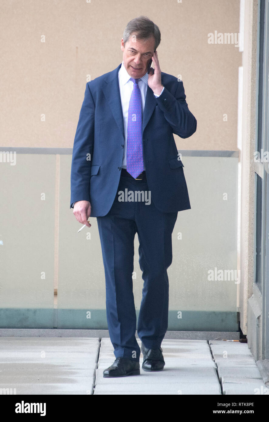 Nigel Farage, Member of the European Parliament, speaks on his cell ...