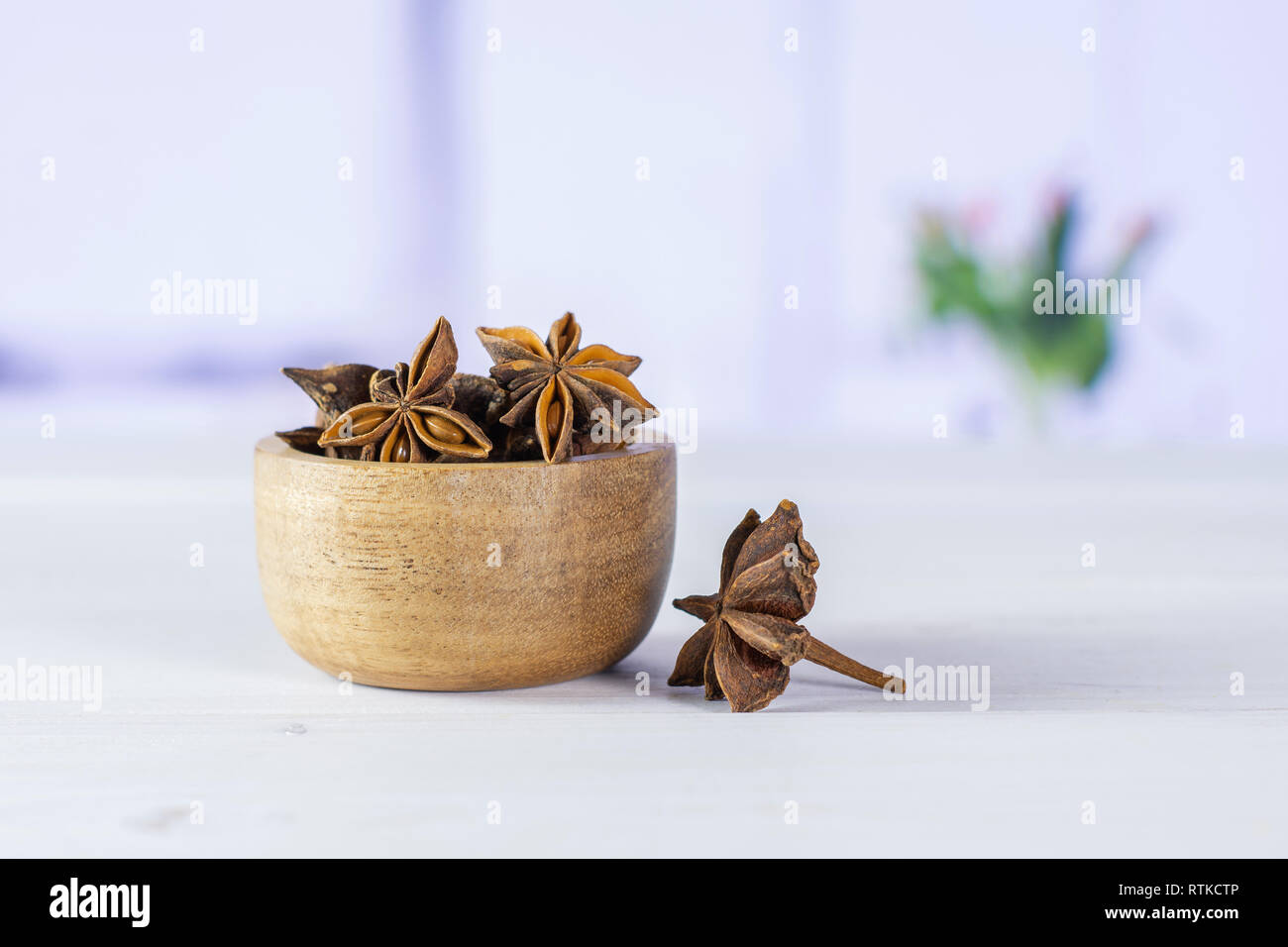 Lot of whole dry brown star anise fruit with wooden bowl with red ...