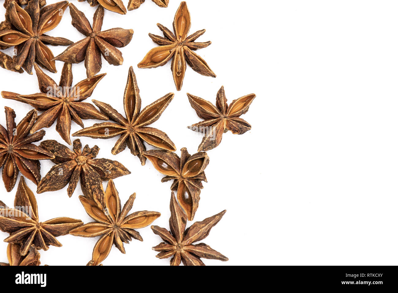 Lot of whole dry brown star anise fruit left corner flatlay isolated on ...