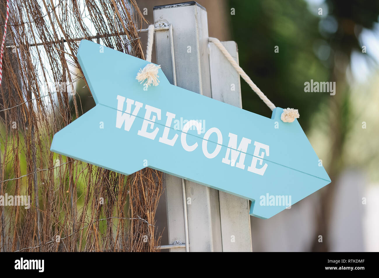 blue wooden sign in the shape of an arrow with the word welcome Stock ...