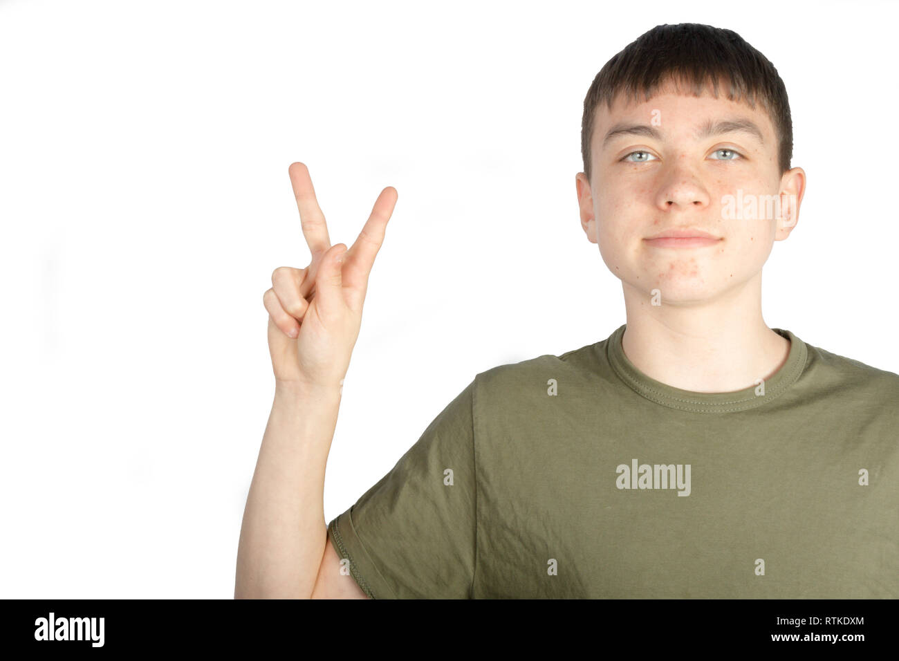 Caucasian teenage boy doing American Sign Language on one hand showing ...