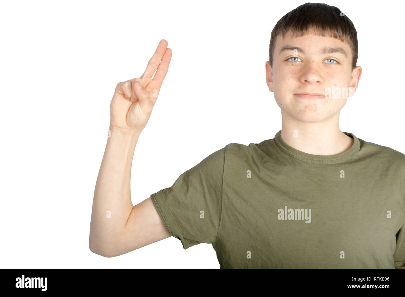 Caucasian teenage boy doing American Sign Language on one hand showing ...