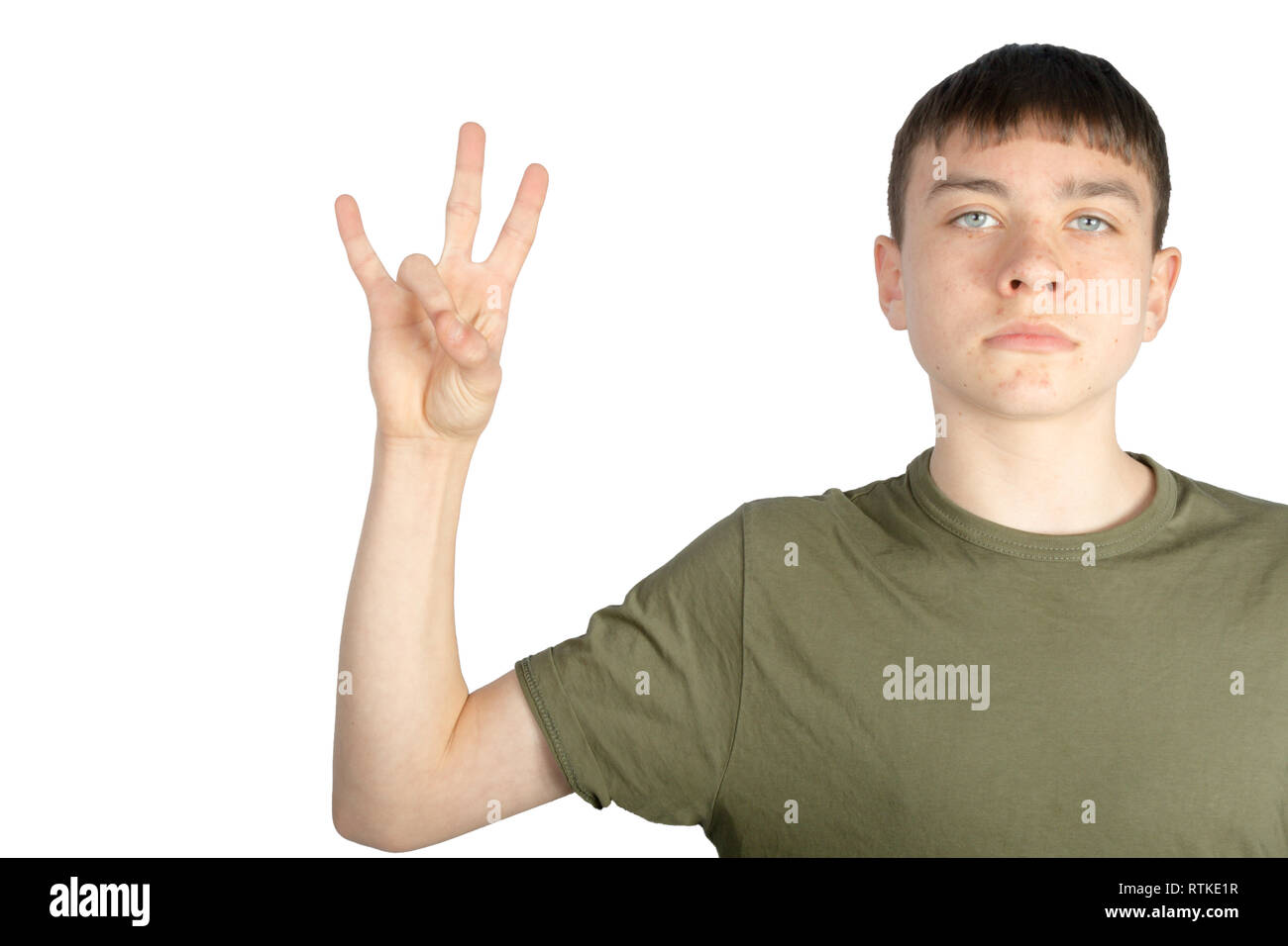 Caucasian teenage boy doing American Sign Language on one hand showing ...