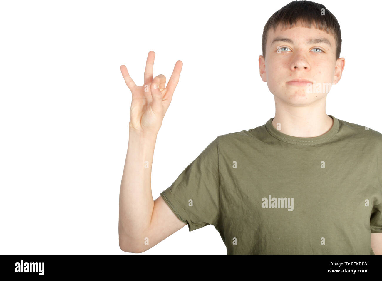 Caucasian teenage boy doing American Sign Language on one hand showing ...