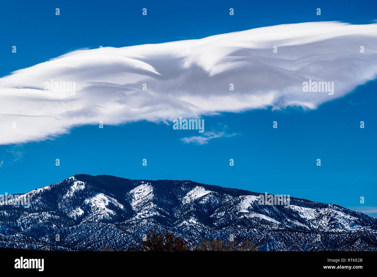 Unusual cloud formations against cobalt blue sky over Rocky Mountains ...