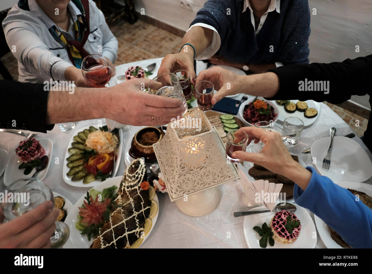Guests toast homemade Samogon distilled alcoholic beverage during a ...
