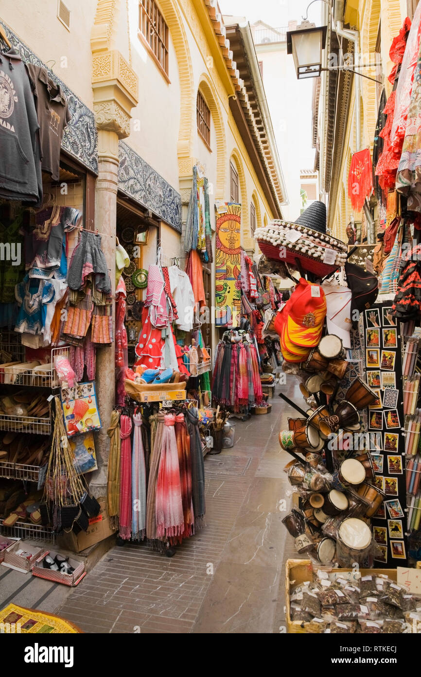 Shopping boutiques along an alleyway at an Arab souk in Granada, Spain ...