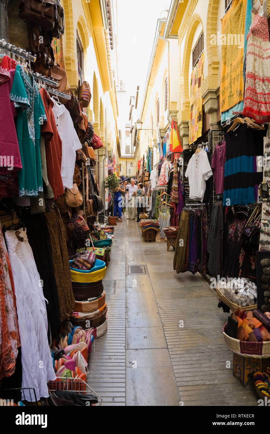 Shopping boutiques along an alleyway at an Arab souk in Granada, Spain ...