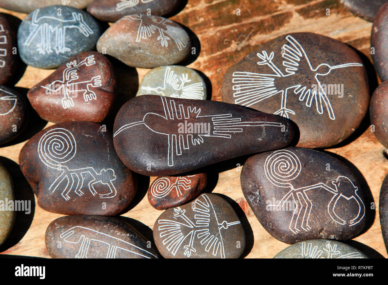 Souvenirs of Nazca lines carved into small rounded stones Stock Photo ...