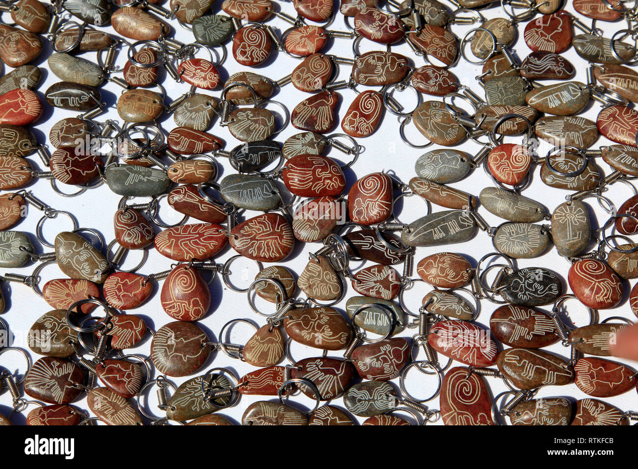 Souvenirs of Nazca lines carved into small rounded stones Stock Photo ...