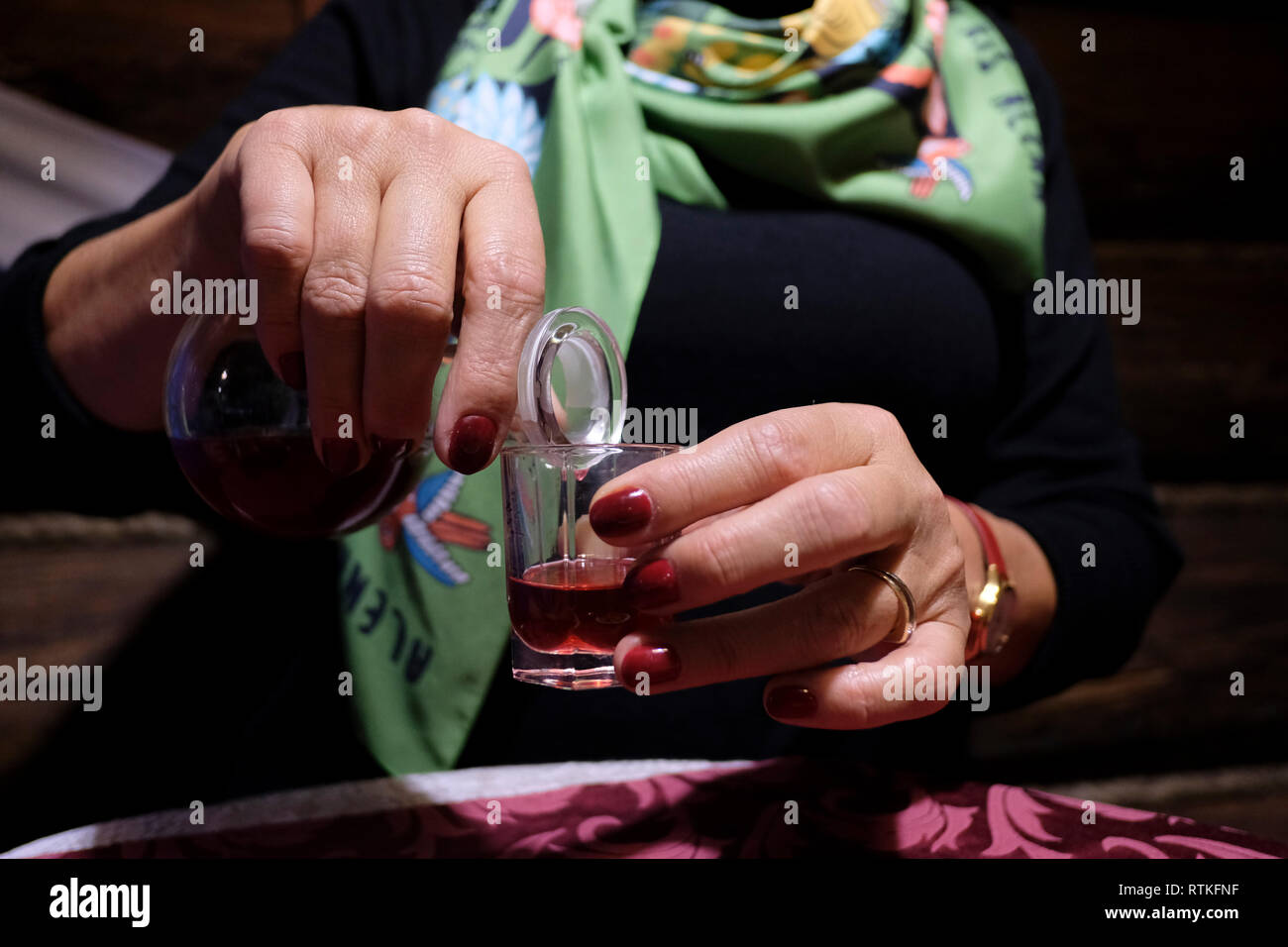 A Belarusian woman pours homemade Samogon distilled alcoholic beverage ...