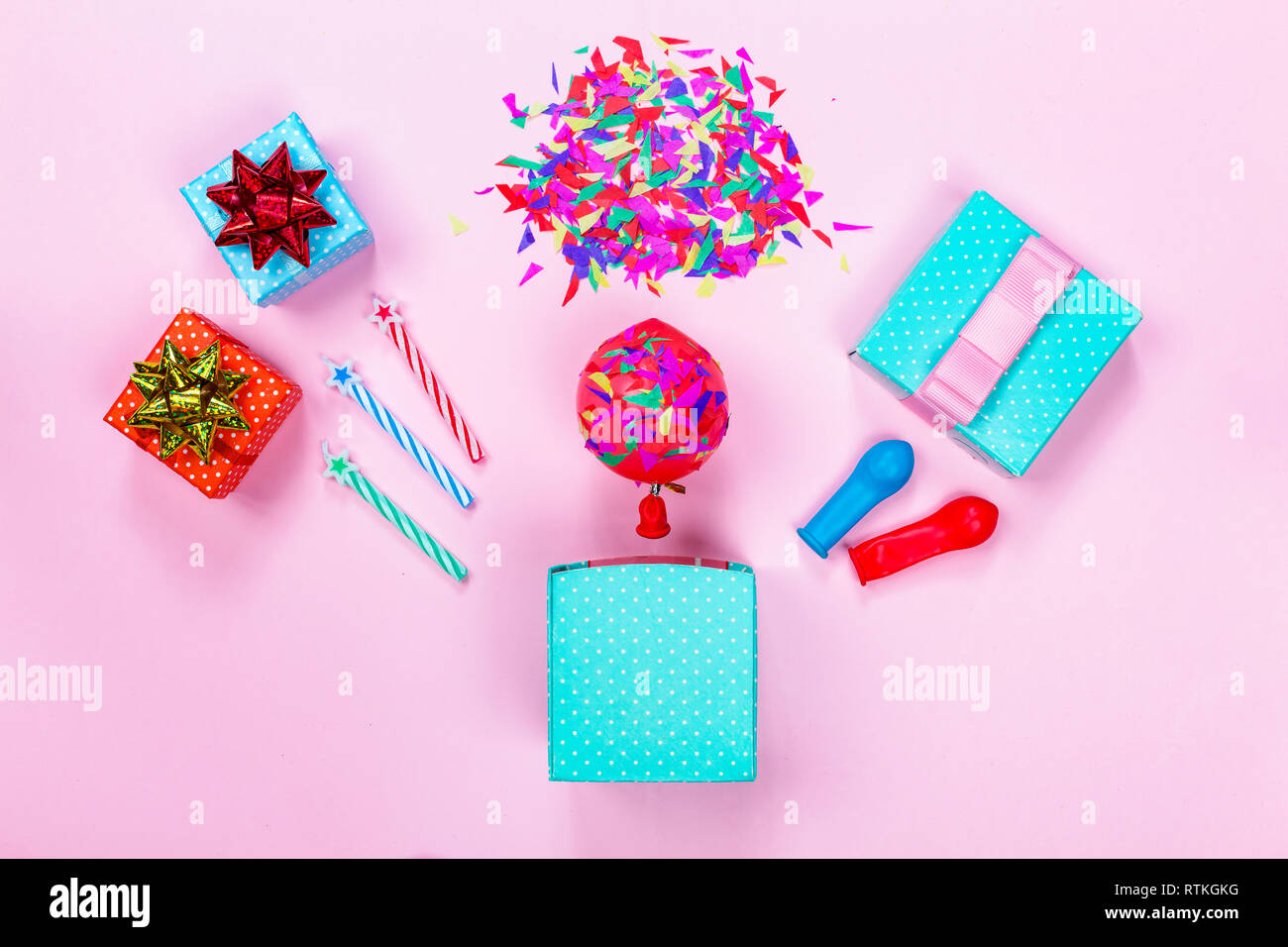 Concept: birthday party. Gift boxes, red and gold bow, colorful candy ...