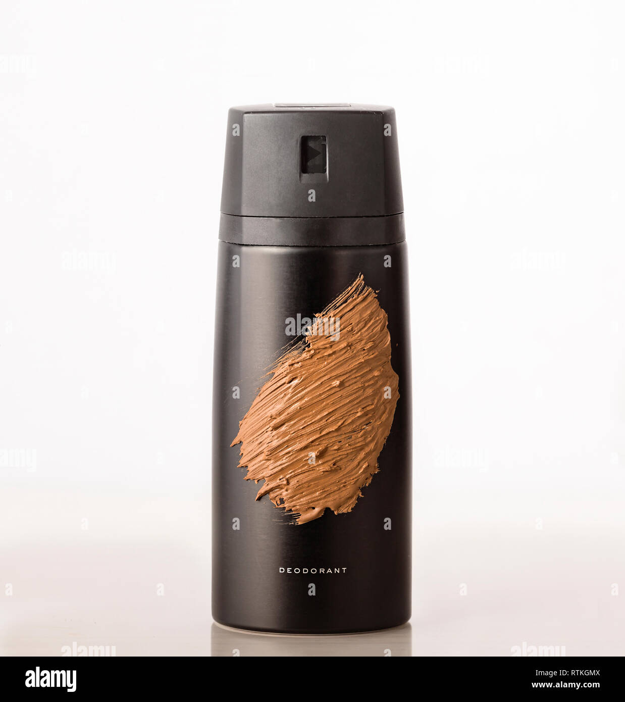 black bottle aerosol deodorant covered with cosmetic clay. Concept ...