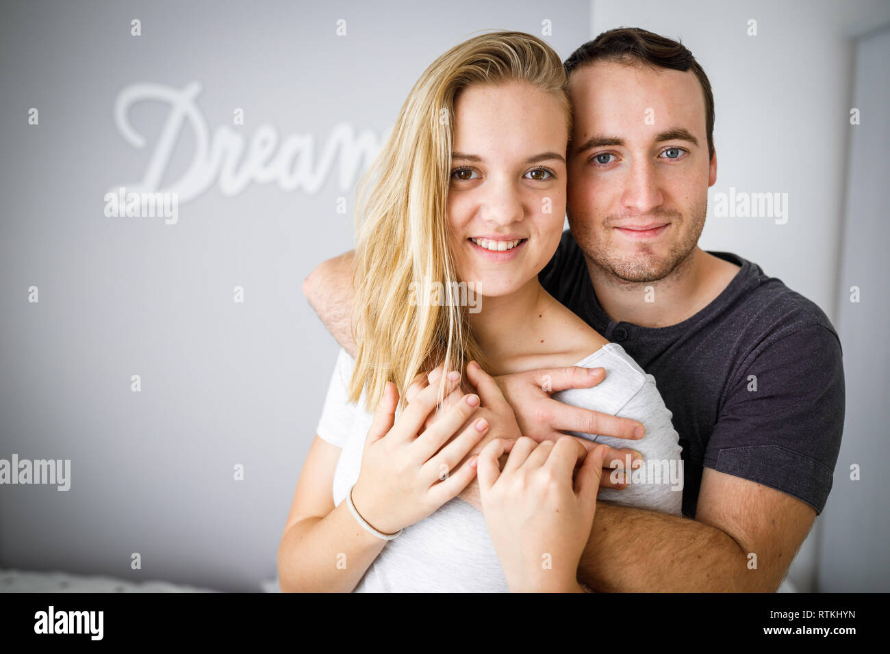 Brother and sister posing for a photo together. Hugging and smiling ...