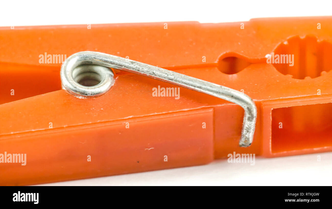 An orange cloth clipper showing the details of it. This is use to hang ...