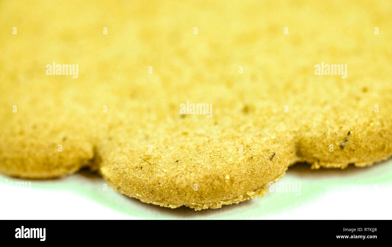 A flat gingerbread on the table. It is brown in color like a brown ...