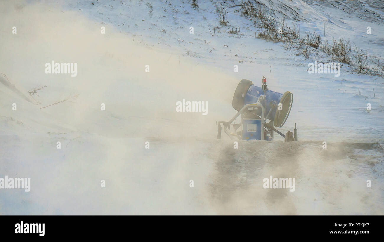 A high pressure blowing of snow by the snow blower on the ski resort ...
