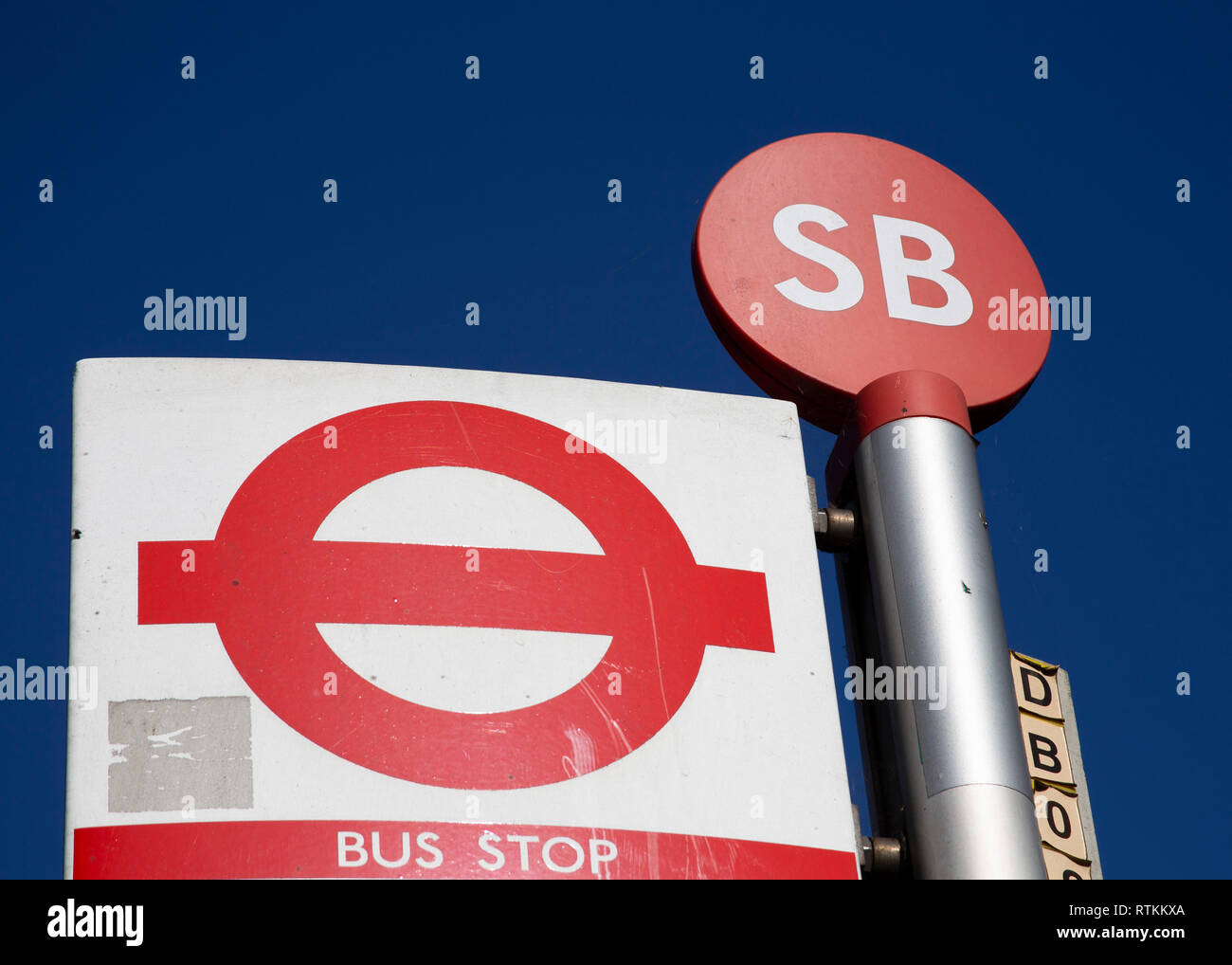 Bus stop sign against a blue sky, London Stock Photo - Alamy