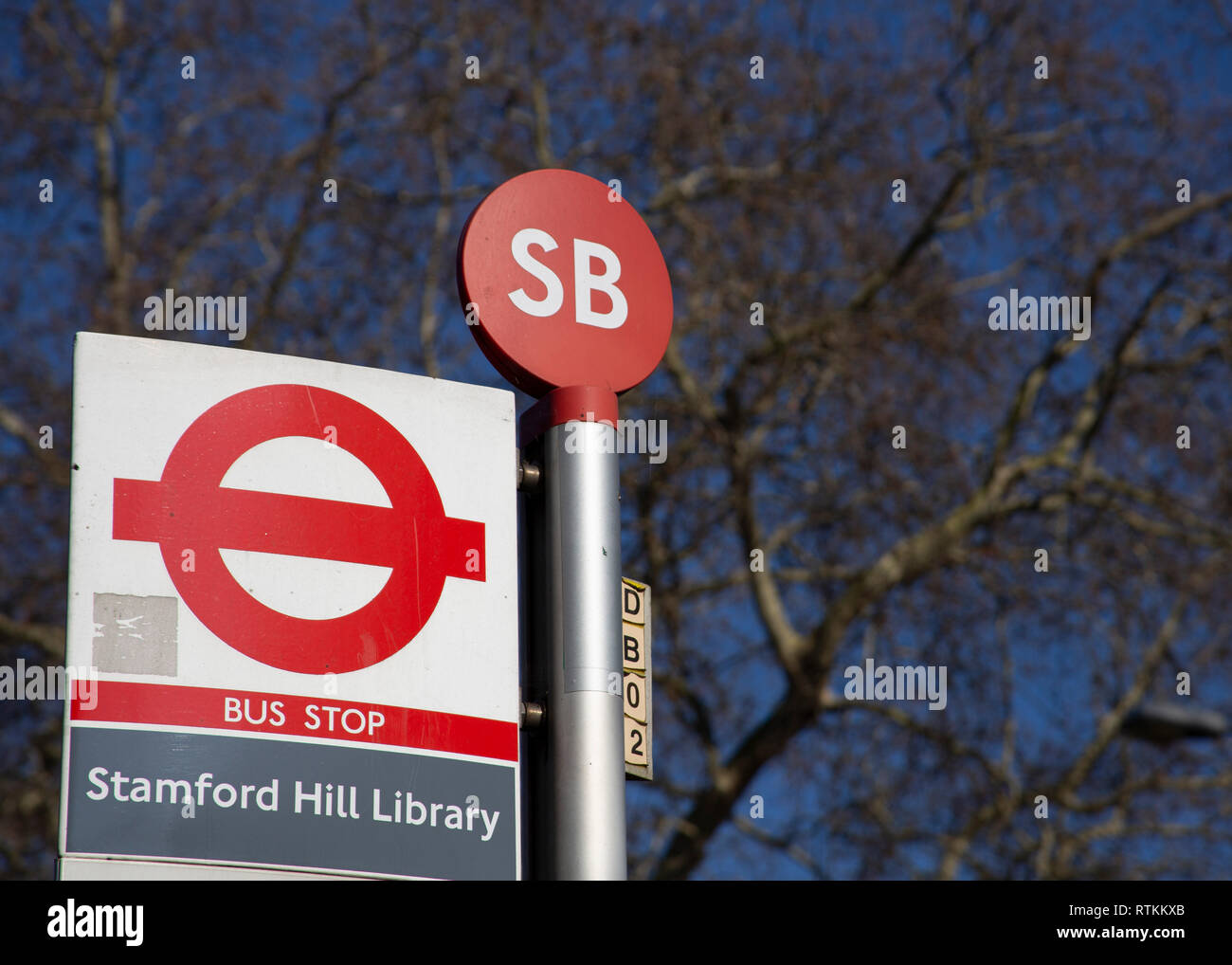 Bus stop sign against a blue sky, London Stock Photo - Alamy