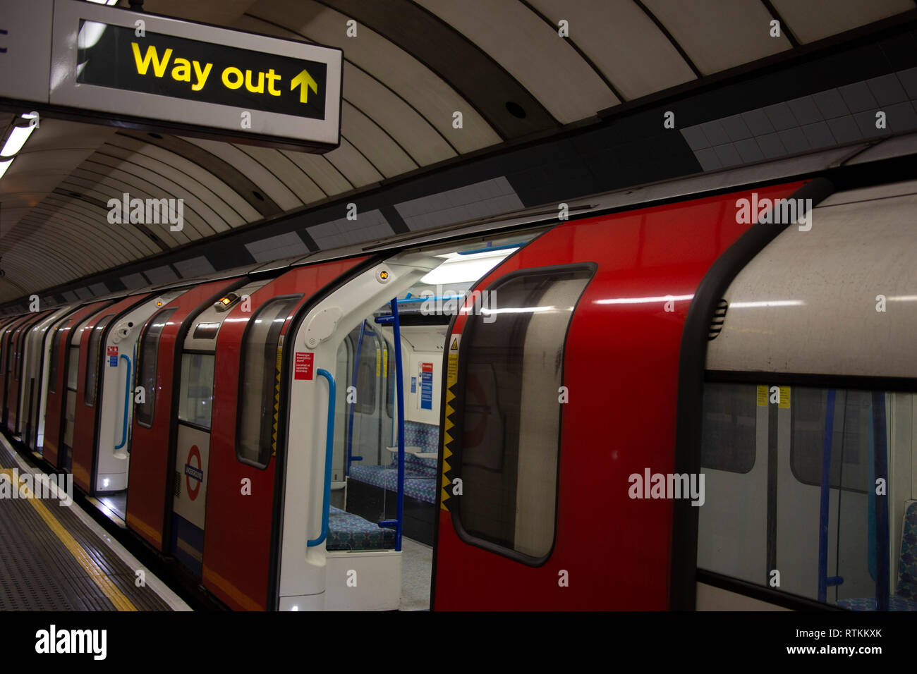 Way out sign at Brixton tube station, with train waiting at platform ...