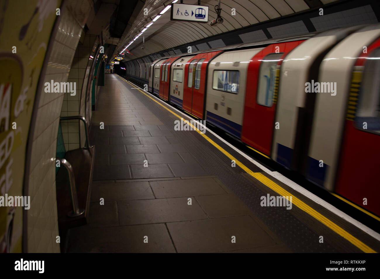 Tube train pulling out of the platform at Brixton Underground Station ...