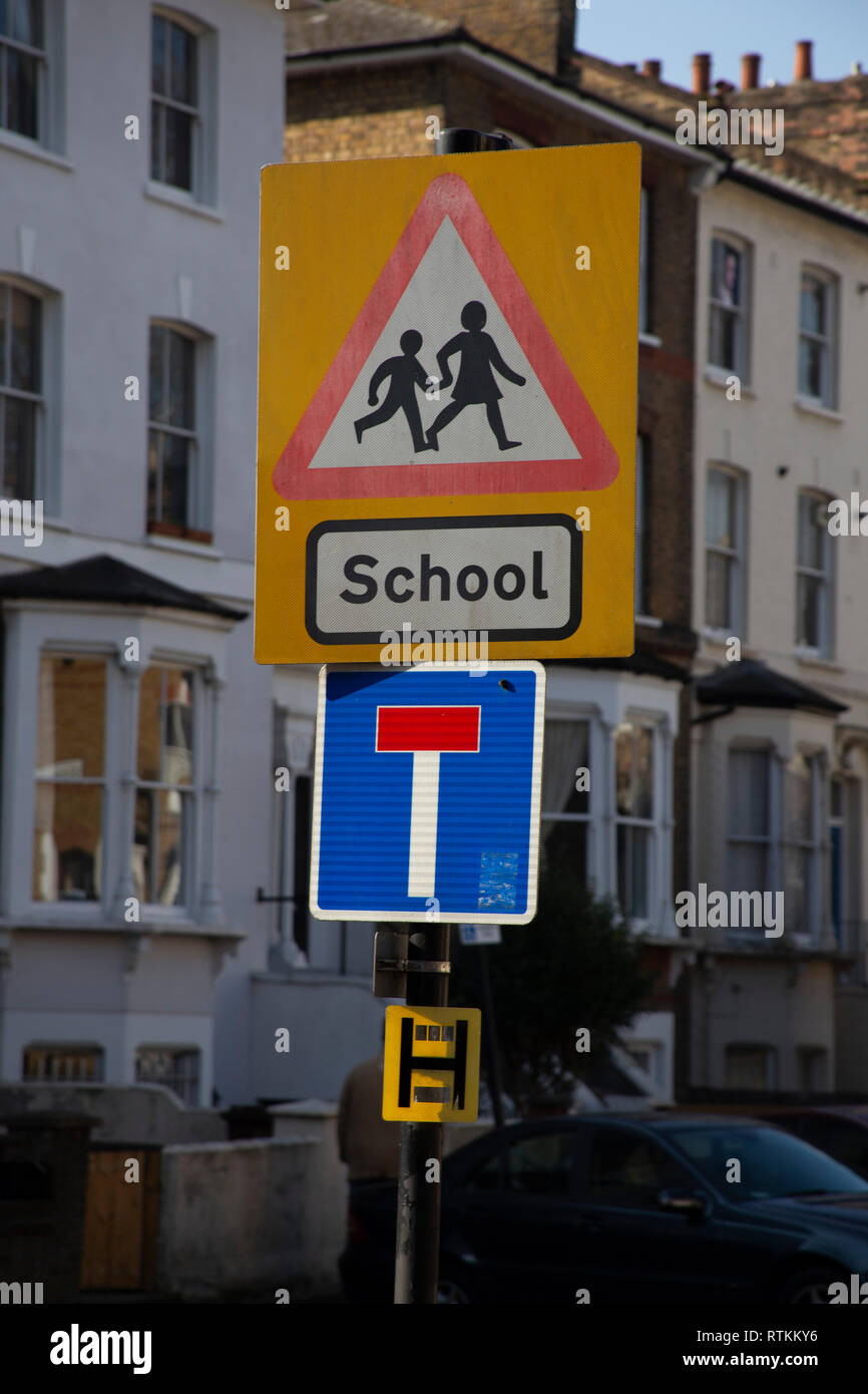 Road signs on residential street in London. School. Dead end ...
