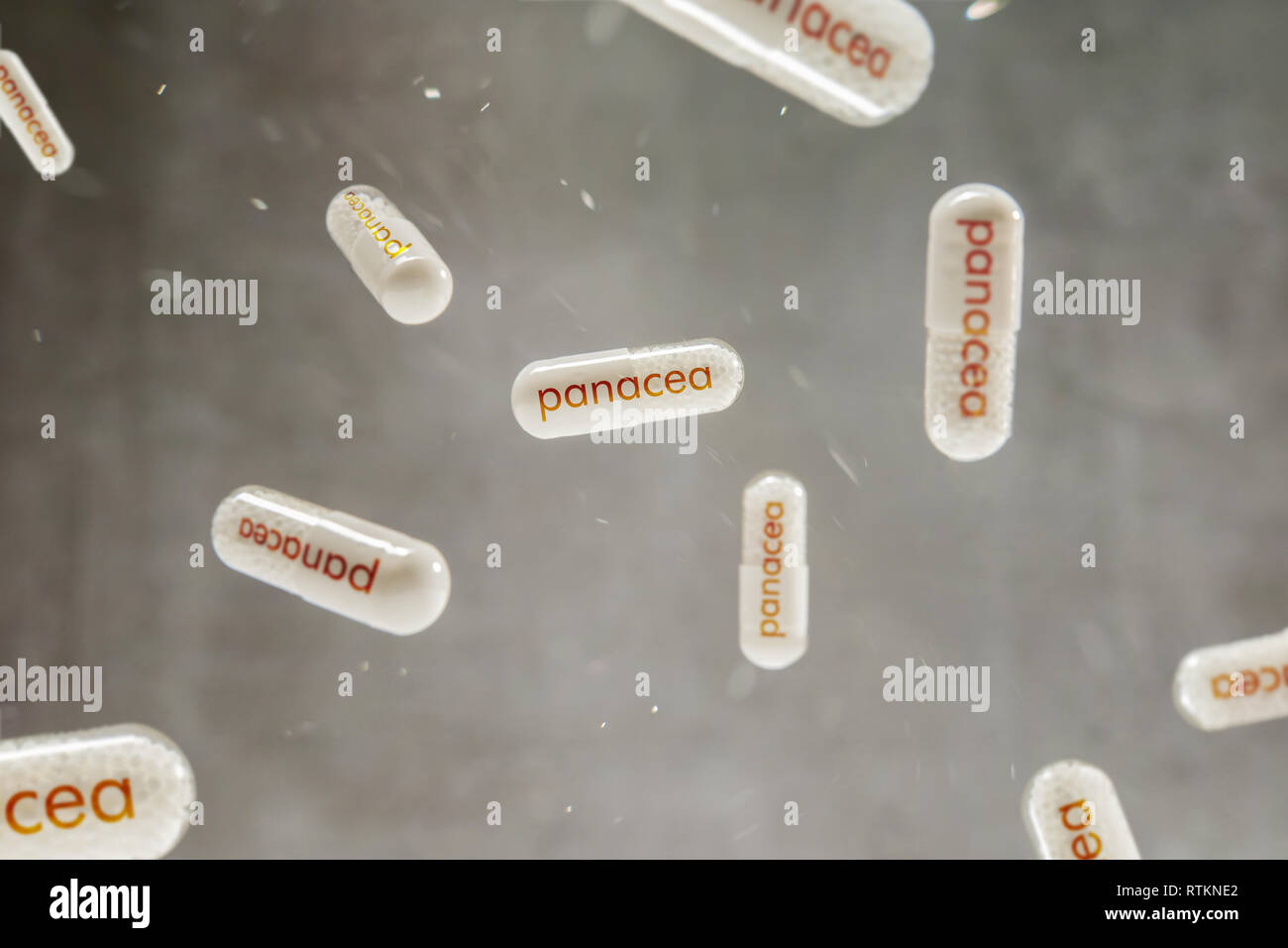 Pills with "panacea" sign hangs on the grey background. Conception of ...