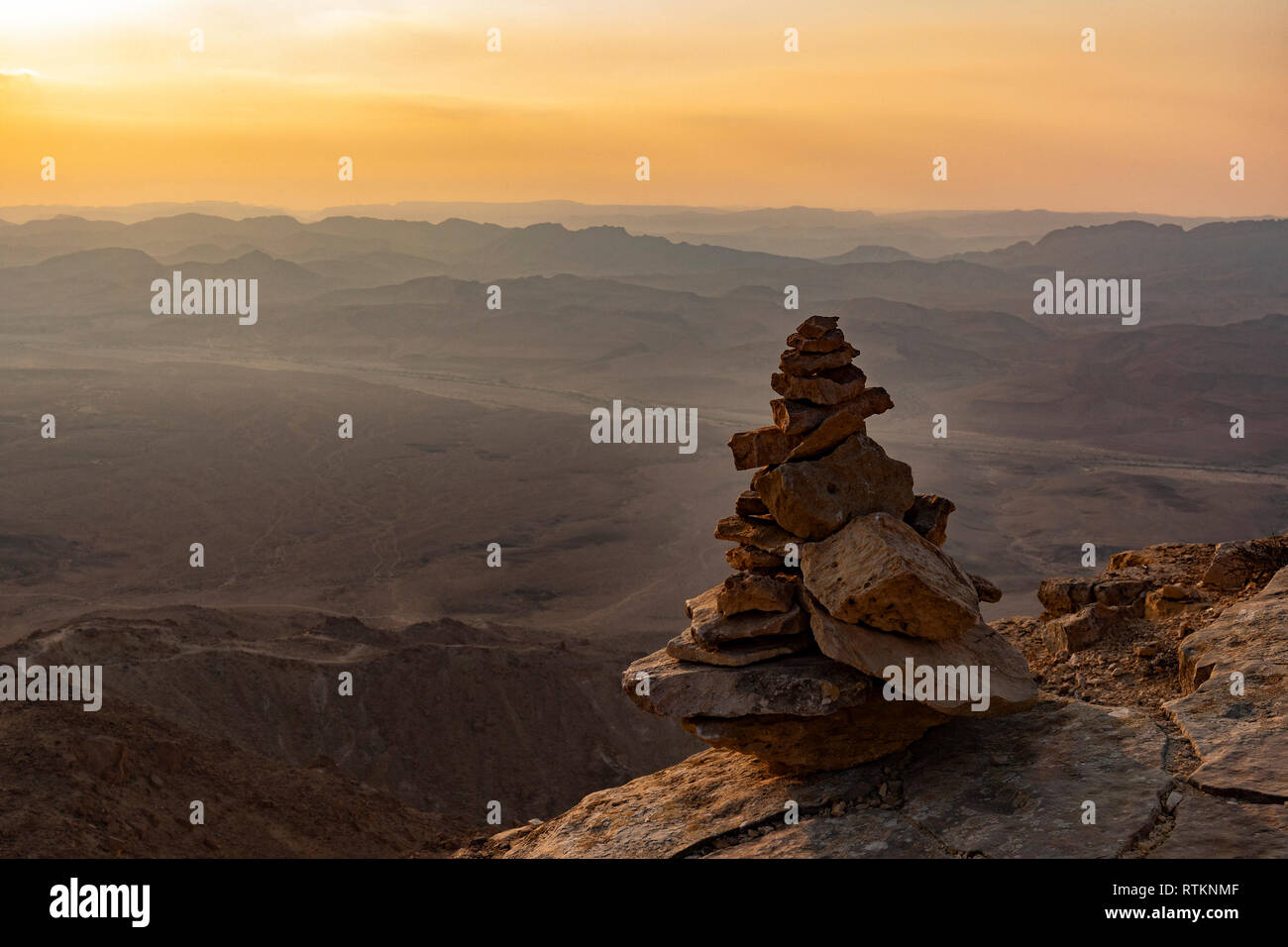 A well balanced pile of stones on the rim of the Ramon crater. Mountain ...