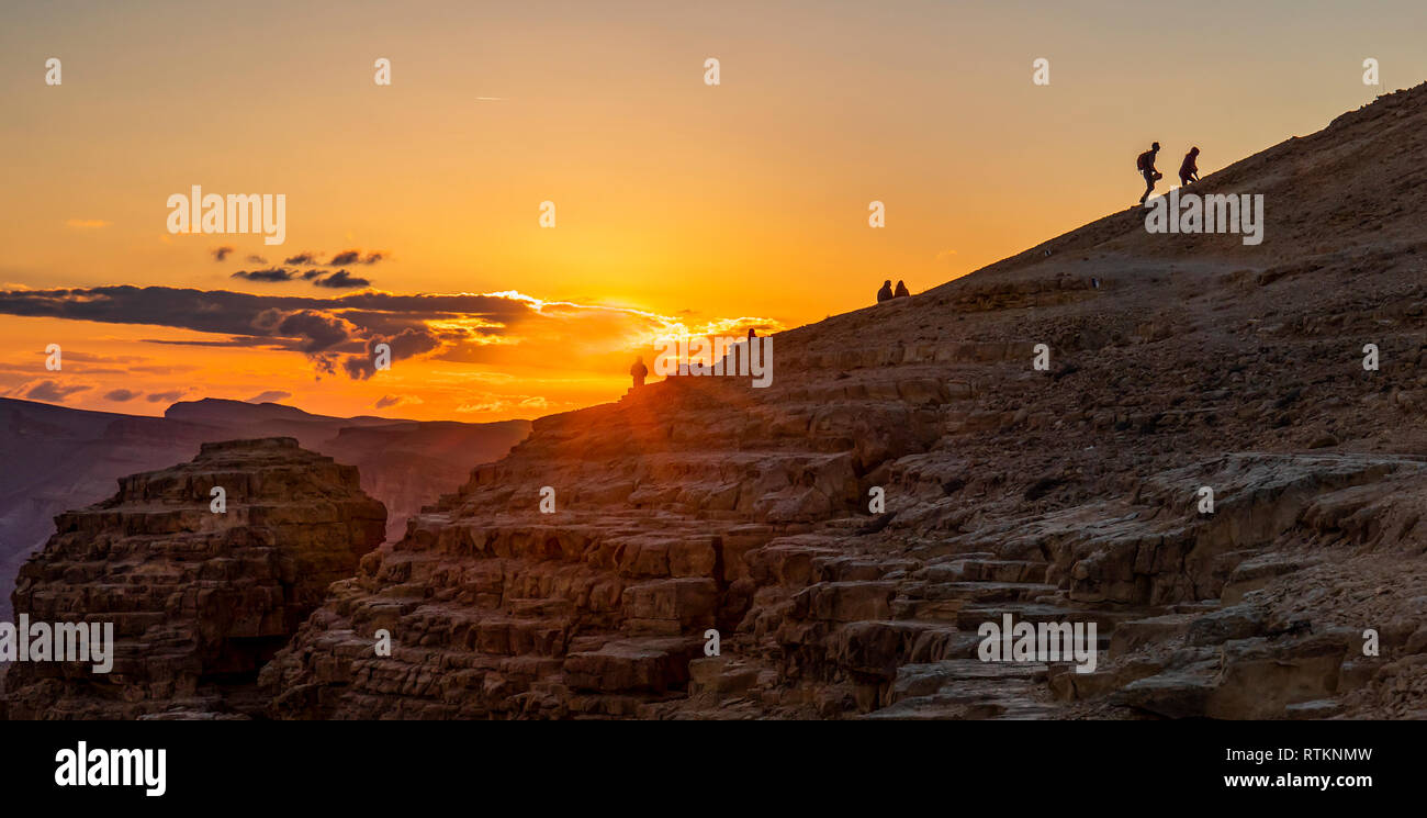 A group of people hiking in the Negev desert in southern Israel, at ...